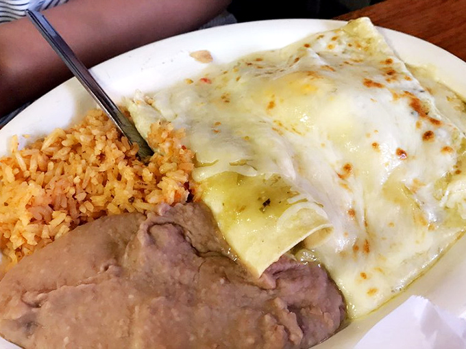 Behold the star of the show &ndash; enchiladas bathed in authentic sauce, accompanied by perfectly executed rice and beans. This plate doesn't just satisfy hunger; it creates memories.
