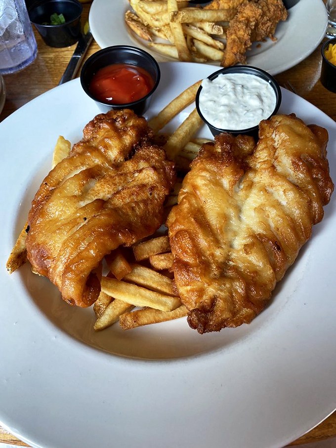 Golden-battered fish filets that shatter at first bite, accompanied by perfectly crisp fries. This is fish and chips nirvana, coastal Carolina style.