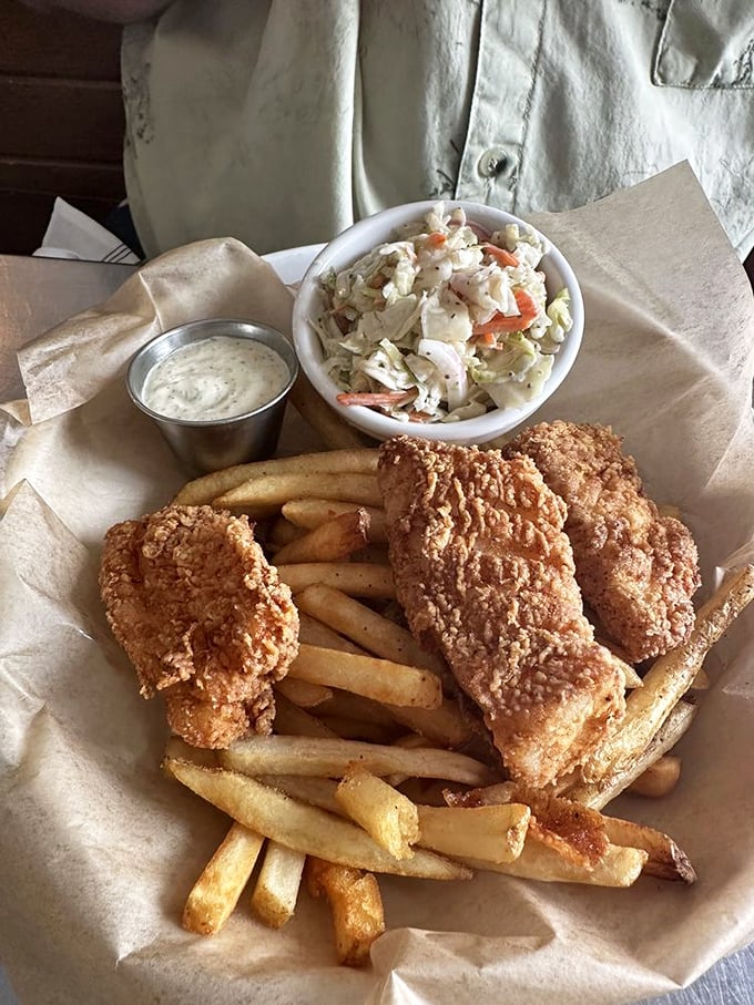 Golden-battered fish that shatters like delicate glass, hand-cut fries with fluffy interiors, and coleslaw that brings the tang. This isn't just fish and chips&mdash;it's edible poetry.