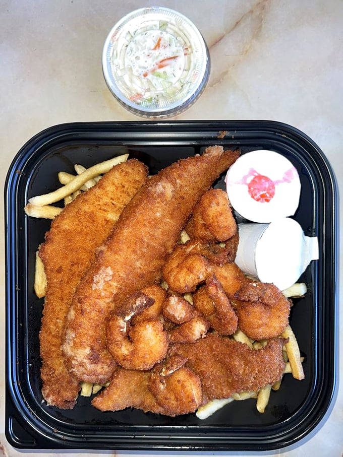 Golden-brown perfection on a plate. This fish and shrimp combo isn't just lunch &ndash; it's a crispy, crunchy masterpiece worth crossing town for.