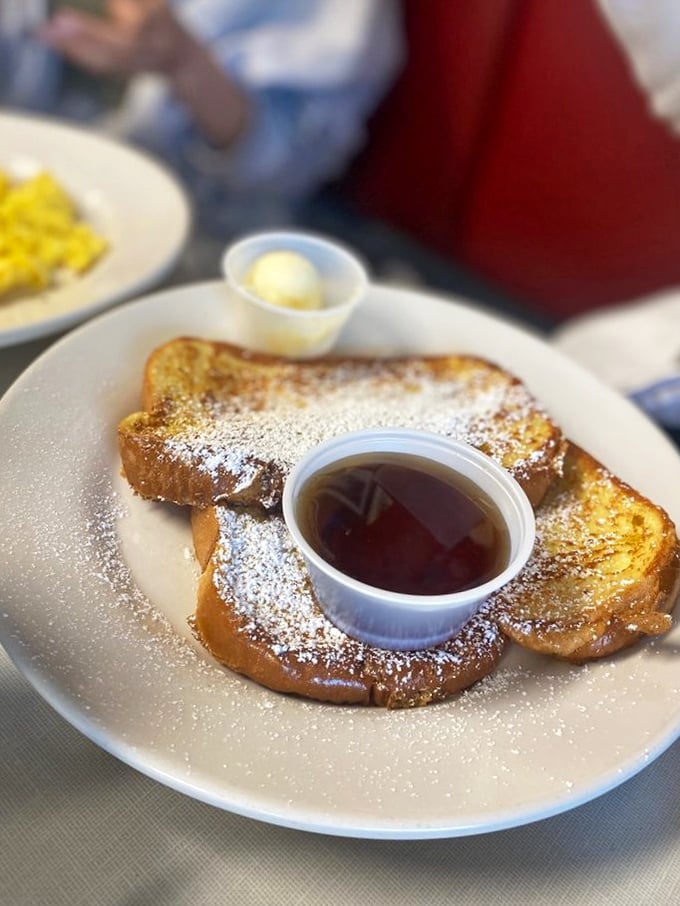 Golden French toast dusted with powdered sugar, waiting for its maple syrup bath. Breakfast doesn't get more photogenic than this&mdash;or more tempting.