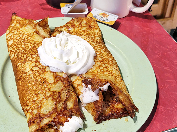 Thin, crispy-edged hotcakes folded like breakfast origami, crowned with clouds of whipped cream. Whoever said "good things come in small packages" never experienced these plate-sized beauties.