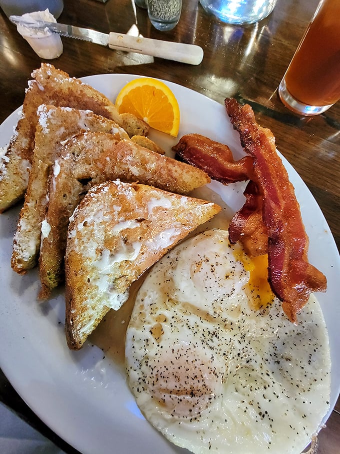 French toast triangles standing at attention next to perfectly cooked eggs and bacon that's achieved that magical state between chewy and crisp.