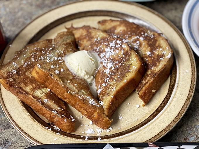 This French toast isn't just breakfast—it's an edible hug, complete with melting butter and a dusting of powdered sugar that whispers, "Take the nap later."