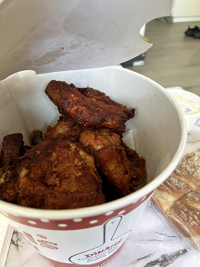 Golden-brown pieces nestled in a paper bucket&mdash;this isn't just fried chicken, it's edible nostalgia that crackles with each bite and soothes the soul.