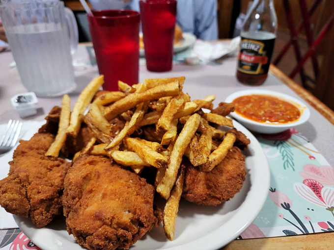 Crispy golden perfection meets hand-cut fries with that signature hot sauce standing by. This isn't just dinner; it's edible therapy.