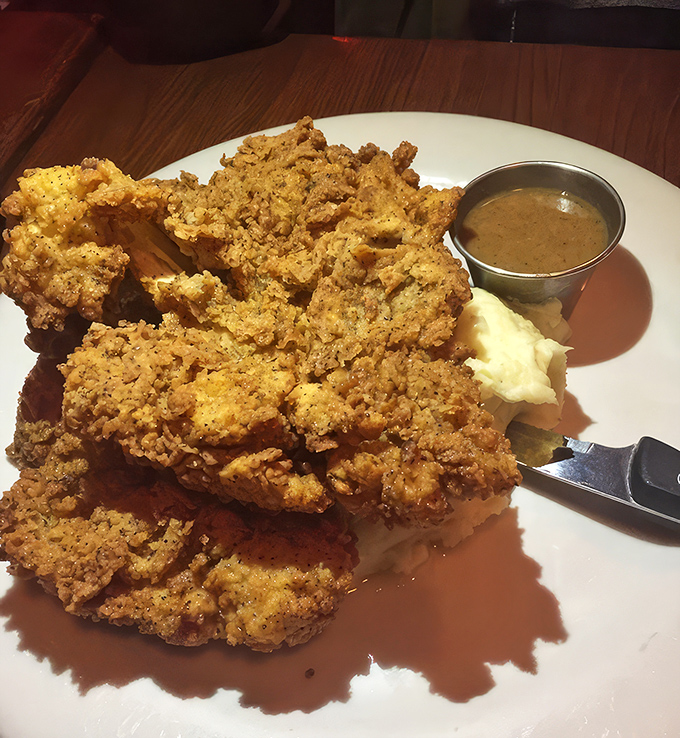 Golden armor shattering to reveal juicy meat beneath&mdash;this fried chicken isn't just a meal, it's an event worth planning your day around.