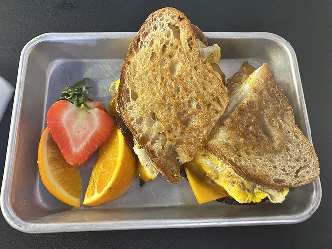 The star of the show: a perfectly grilled sandwich served with fresh fruit that makes you wonder why you ever settled for drive-thru breakfast.