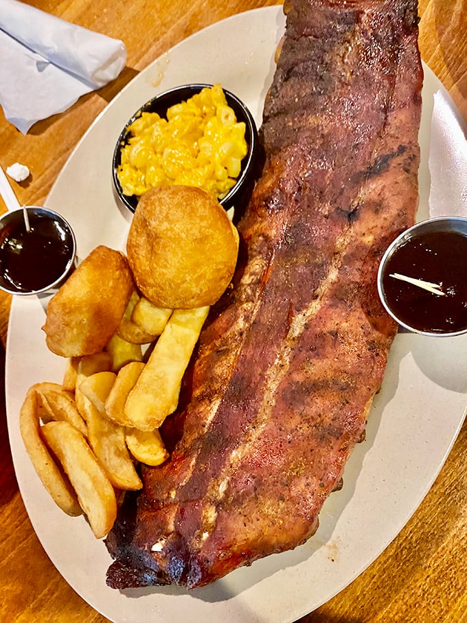 Behold the rack of ribs in its natural habitat&mdash;surrounded by mac and cheese, fries, and two dipping sauces for strategic flavor deployment.