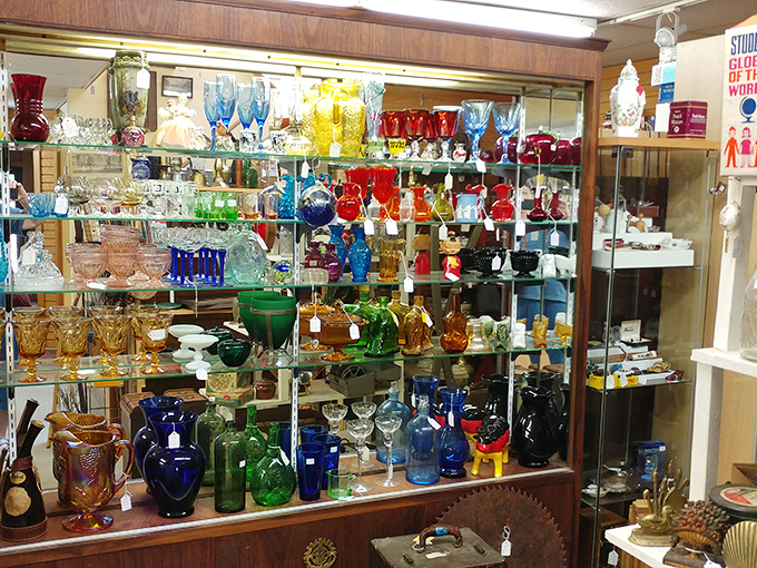 A rainbow of vintage glassware catches the light like a stained-glass window in a cathedral of collectibles. Depression glass has never looked so happy!