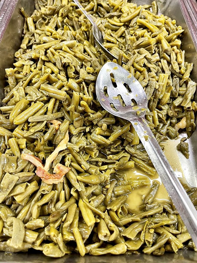 These aren't your fancy restaurant green beans. They've been simmering with ham hocks since morning, transforming into something your grandmother would approve of.