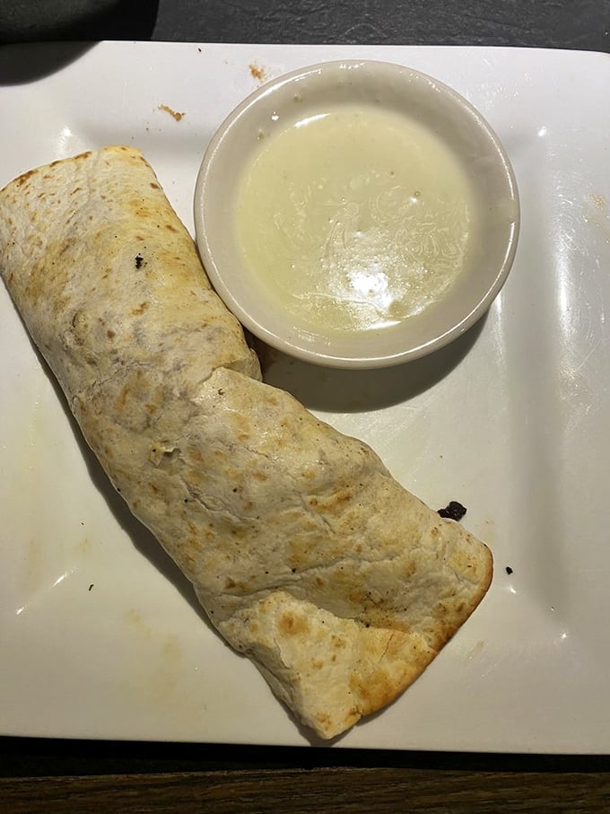 Behold the legendary green chili burrito in its natural habitat&mdash;a simple white plate that has no idea it's about to host a flavor explosion.