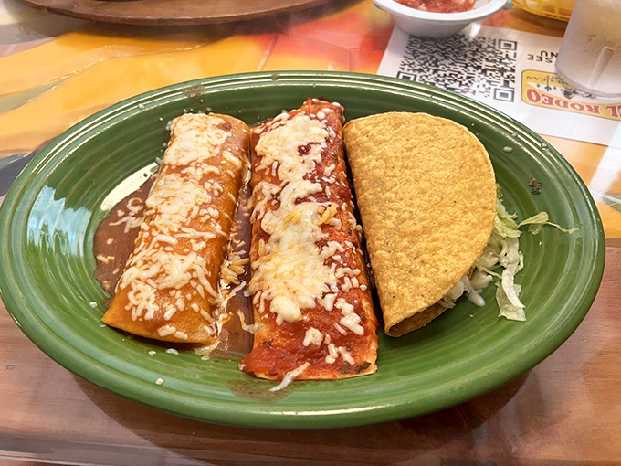 This isn't just lunch, it's a flavor fiesta. Two enchiladas bathed in sauce and cheese alongside a perfectly crisp taco&mdash;the holy trinity of Mexican comfort food.