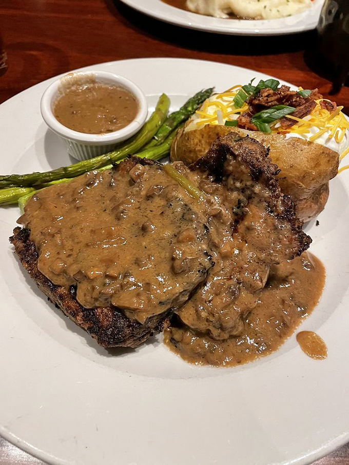 This isn't just any steak&mdash;it's a perfectly seared masterpiece crowned with mushroom gravy that would make even vegetarians reconsider their life choices.