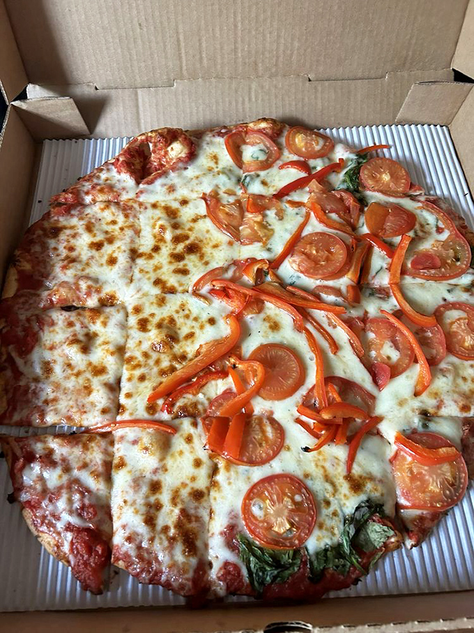 Pizza duality at its finest! Half classic cheese, half loaded with fresh tomatoes and peppers&mdash;like having your cake and eating pizza too.