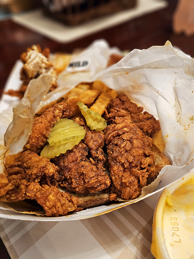 The holy grail of Nashville hot chicken &ndash; crispy, ruddy-hued, and nestled on white bread that soaks up all that glorious spiced oil like edible treasure.
