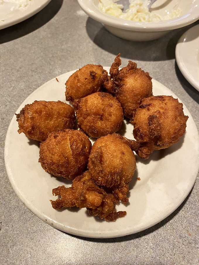 Golden orbs of cornmeal perfection that would make your grandmother weep with joy. These hush puppies aren't just appetizers&mdash;they're edible Southern poetry.