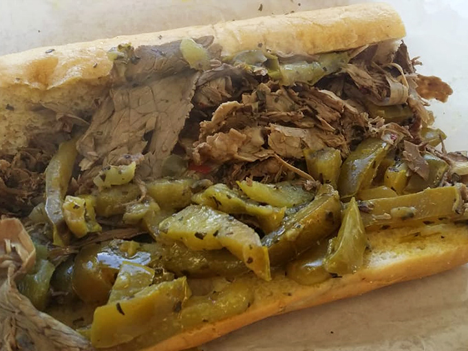 Behold the crown jewel: thinly-sliced beef tucked into that perfect bread, with hot giardiniera adding the kick that makes life worth living.