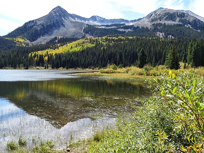 Nature showing off again at Kebler Pass. The mountains reflect in still waters like they're admiring their own magnificence.