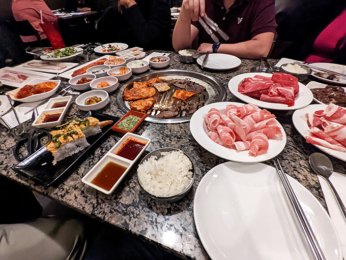 Tabletop theater at its most delicious: thinly sliced meats, vibrant banchan, and a grill that transforms ordinary dinner into interactive art.