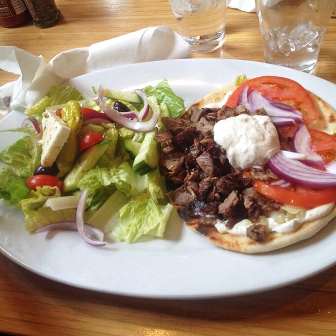 A proper lamb gyro doesn't need fancy plating &ndash; just perfectly seasoned meat, fresh veggies, and tzatziki that would make Zeus himself weep with joy.
