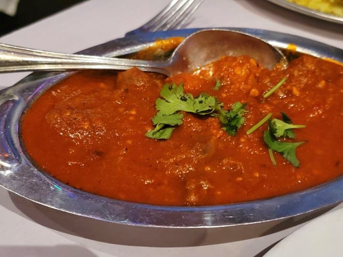 This isn't just curry, it's a sunset in a bowl. The vibrant sauce cradles tender morsels while cilantro adds that perfect fresh finish.