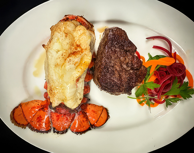 Surf and turf perfection on a plate. The lobster tail practically glows with buttery promise beside its beefy companion.