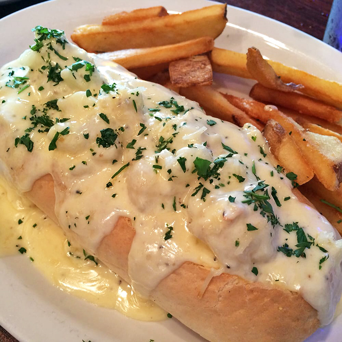 The lobster roll that launched a thousand road trips. Buttery, toasted perfection cradling sweet lobster meat, with golden fries standing guard.