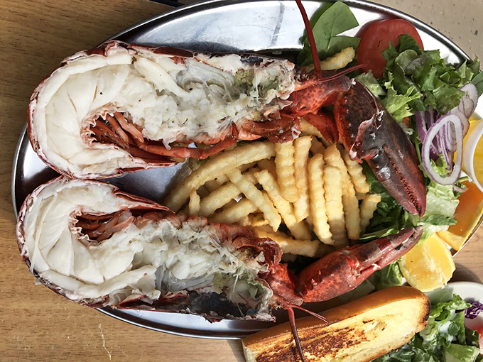 Split lobster that looks like it just called a time-out from the ocean. Served with crispy fries and fresh greens, this is coastal luxury without pretension.
