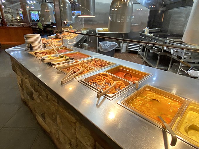 Buffet stations stretching toward the horizon like a food mirage that's gloriously real. Each metal tray holds a different comfort food classic.