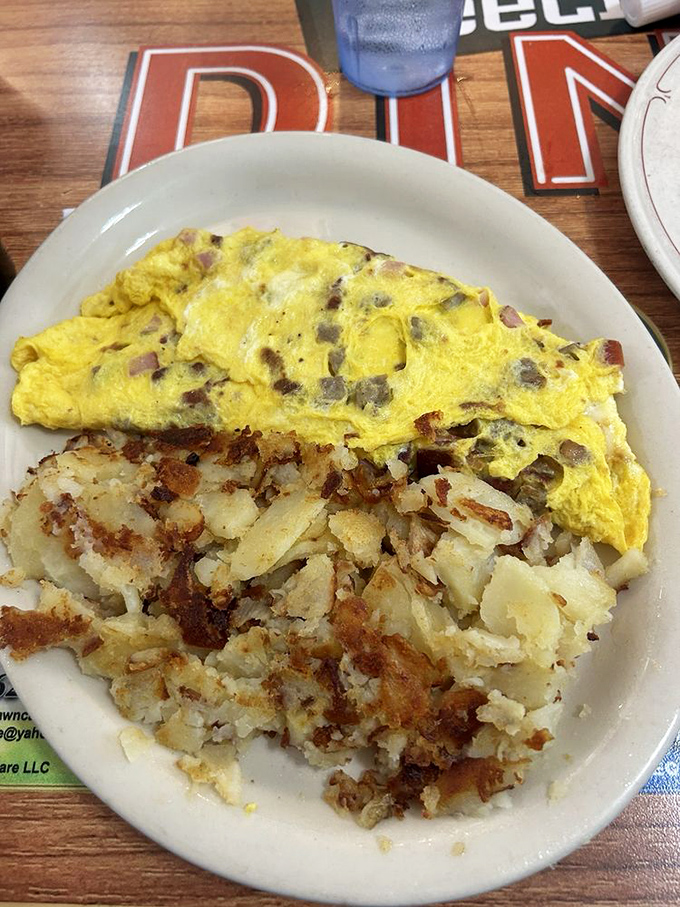 The Meat Lovers Omelet doesn't just contain meat&mdash;it celebrates it. Those golden-brown home fries aren't just a side dish; they're an essential supporting character.