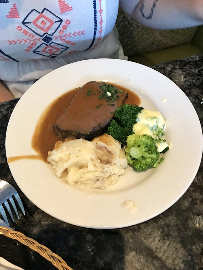 Behold the star attraction—meatloaf bathed in savory gravy alongside cloud-like mashed potatoes. Comfort food that graduated with honors.