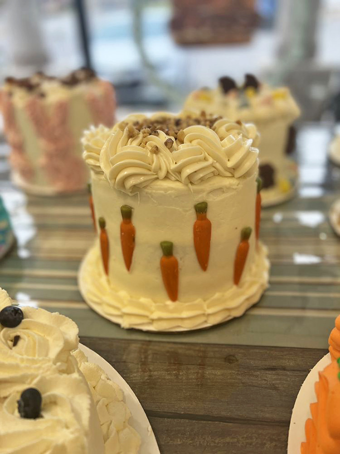 This mini carrot cake is architectural perfection—those tiny marzipan carrots aren't just decoration, they're a promise of the moistness waiting inside.