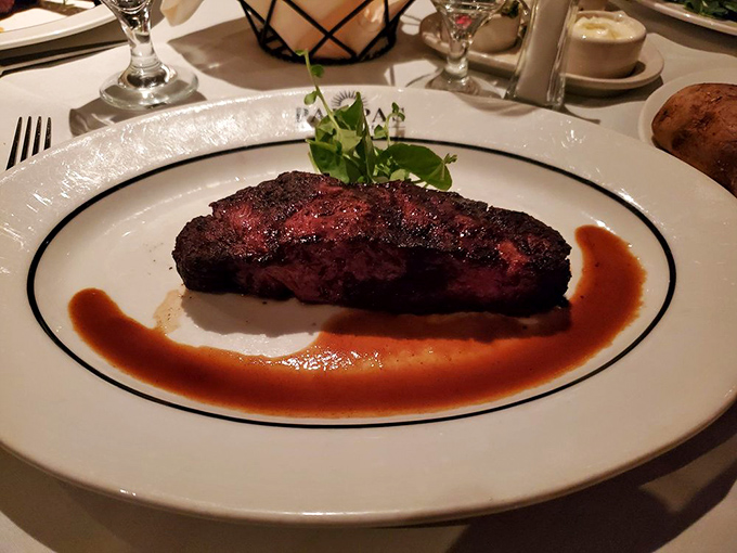 Behold the star of our show: a perfectly seared New York Strip with that textbook ruby center. This isn't dinner&mdash;it's performance art.