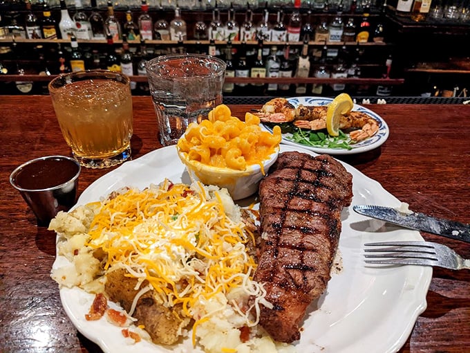 A loaded baked potato that could feed a small village sits beside a perfectly grilled steak&mdash;this is comfort food with cowboy credentials.