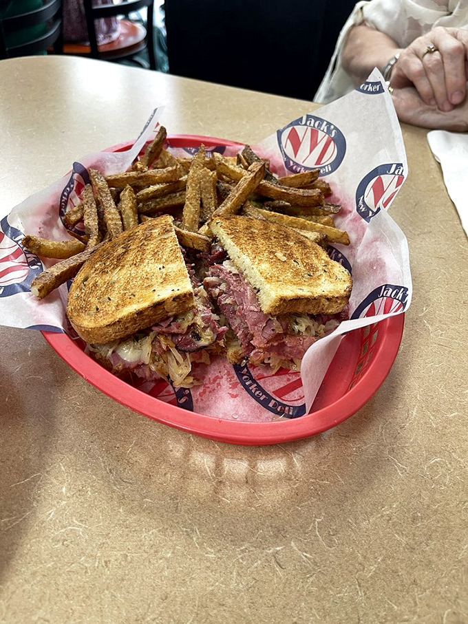 Behold the Reuben in its natural habitat&mdash;perfectly grilled rye, meat stacked higher than Manhattan rent, with crispy fries standing guard.