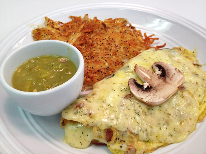 This isn't just an omelet; it's a cheese-draped miracle with perfectly sautéed mushrooms. The crispy hash browns could make a potato farmer weep with pride.