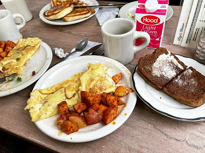 Breakfast nirvana on a plate: a fluffy omelet that's seen the perfect amount of heat, home fries with that ideal crisp-tender balance, and toast ready for its butter bath.