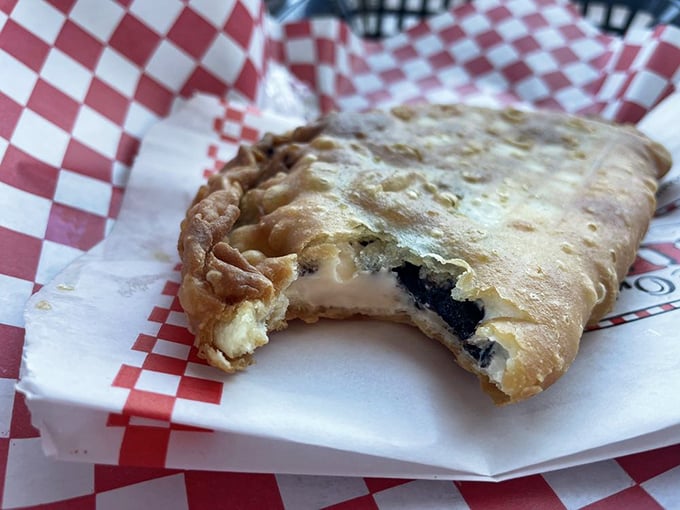 Behold the Oreo cheesecake fried pie in its natural habitat&mdash;half-eaten because nobody has the willpower to pause for photos before diving in.