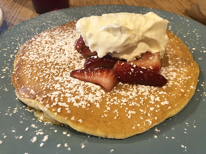 Pancake perfection topped with fresh strawberries and a cloud of whipped cream. This isn't breakfast&mdash;it's dessert with permission slips signed by the breakfast gods.