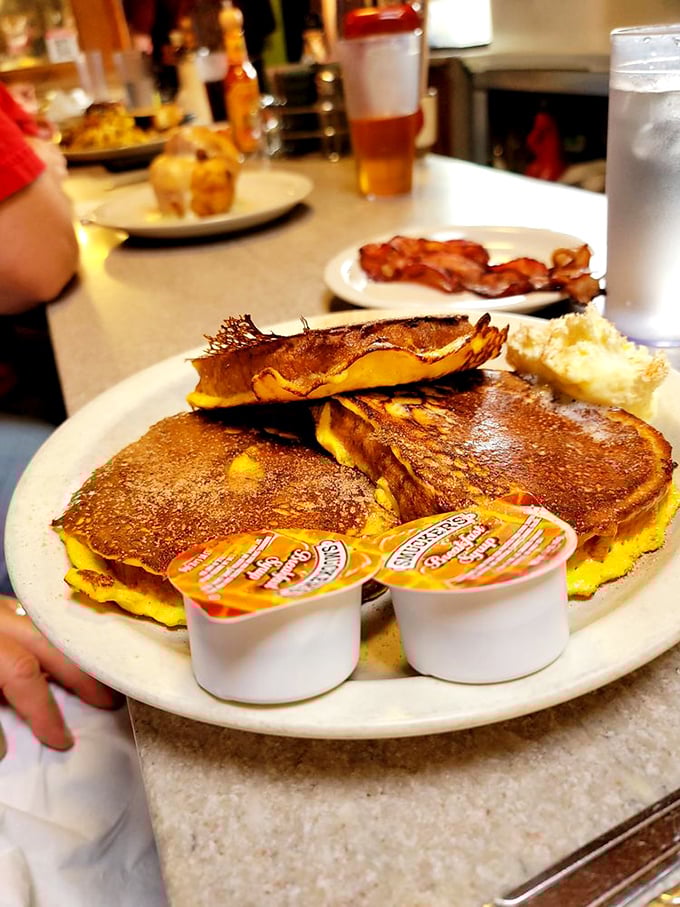 The pancake stack that launched a thousand food comas. That melting butter pat is performing its own little breakfast ballet.