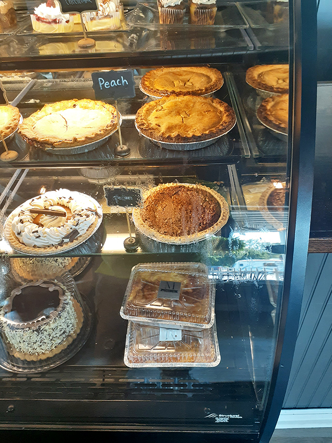 Decisions, decisions. The glass case at Marilyn's isn't just a display—it's a museum of edible masterpieces waiting for approval.