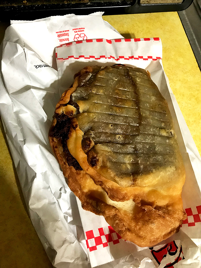 This isn't just a fried pie&mdash;it's edible architecture with crisp, ridged edges giving way to a dark, mysterious filling that promises satisfaction.