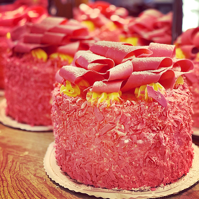 These pink champagne cakes aren't just desserts&mdash;they're edible architecture with those perfect chocolate curls standing like delicious sentinels of sweetness.