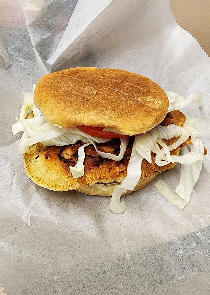 The legendary pork chop sandwich in all its glory&mdash;crispy breaded meat, tangy slaw, and just the right amount of mess-making potential.