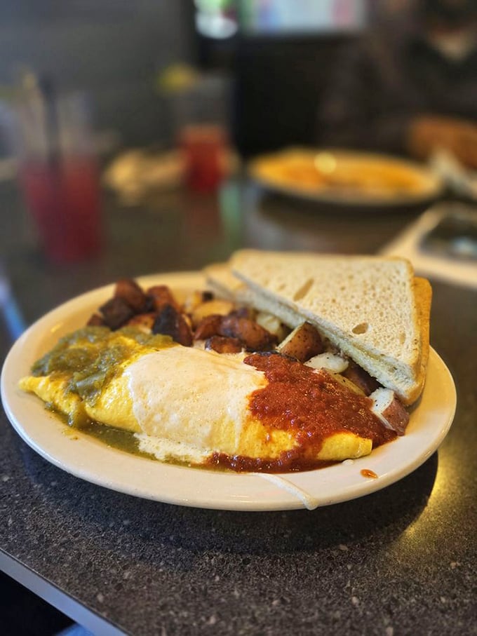 This isn't just breakfast, it's edible art &ndash; a technicolor omelet draped in dueling sauces with home fries that could make a potato farmer weep with pride.