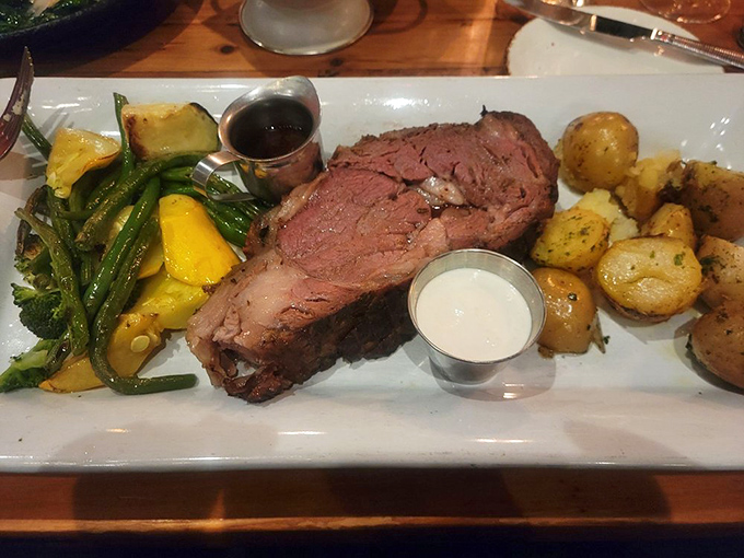 The star of the show arrives: Prime rib cooked to that magical sweet spot where the exterior forms a savory crust while the interior remains perfectly pink and juicy.