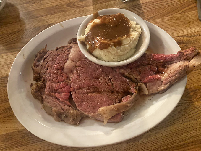 Prime rib so perfectly pink it should have its own Instagram account, accompanied by mashed potatoes drowning gloriously in gravy.