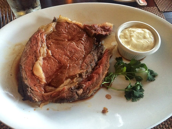 Prime rib perfection &ndash; a rosy interior that would make even the most stoic diner weak at the knees. That parsley garnish isn't just for show. 