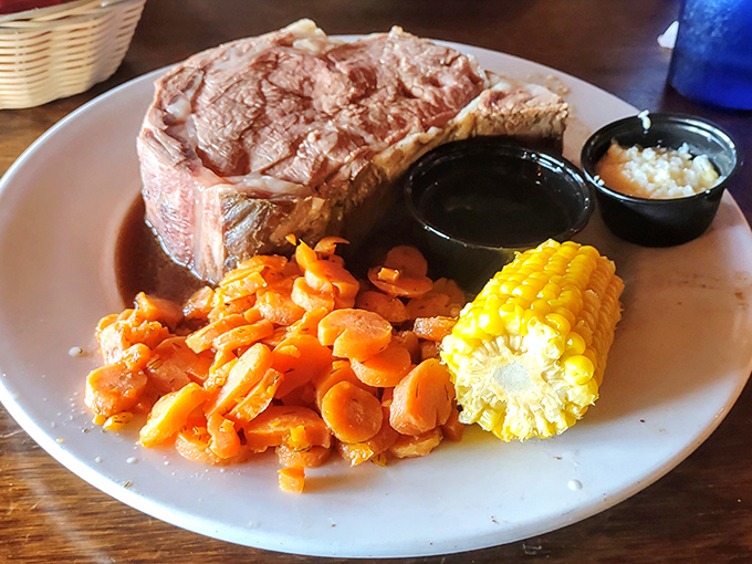 The star of the show in its natural habitat: prime rib so perfectly pink it blushes, accompanied by carrots that clearly got the memo about bringing their A-game.